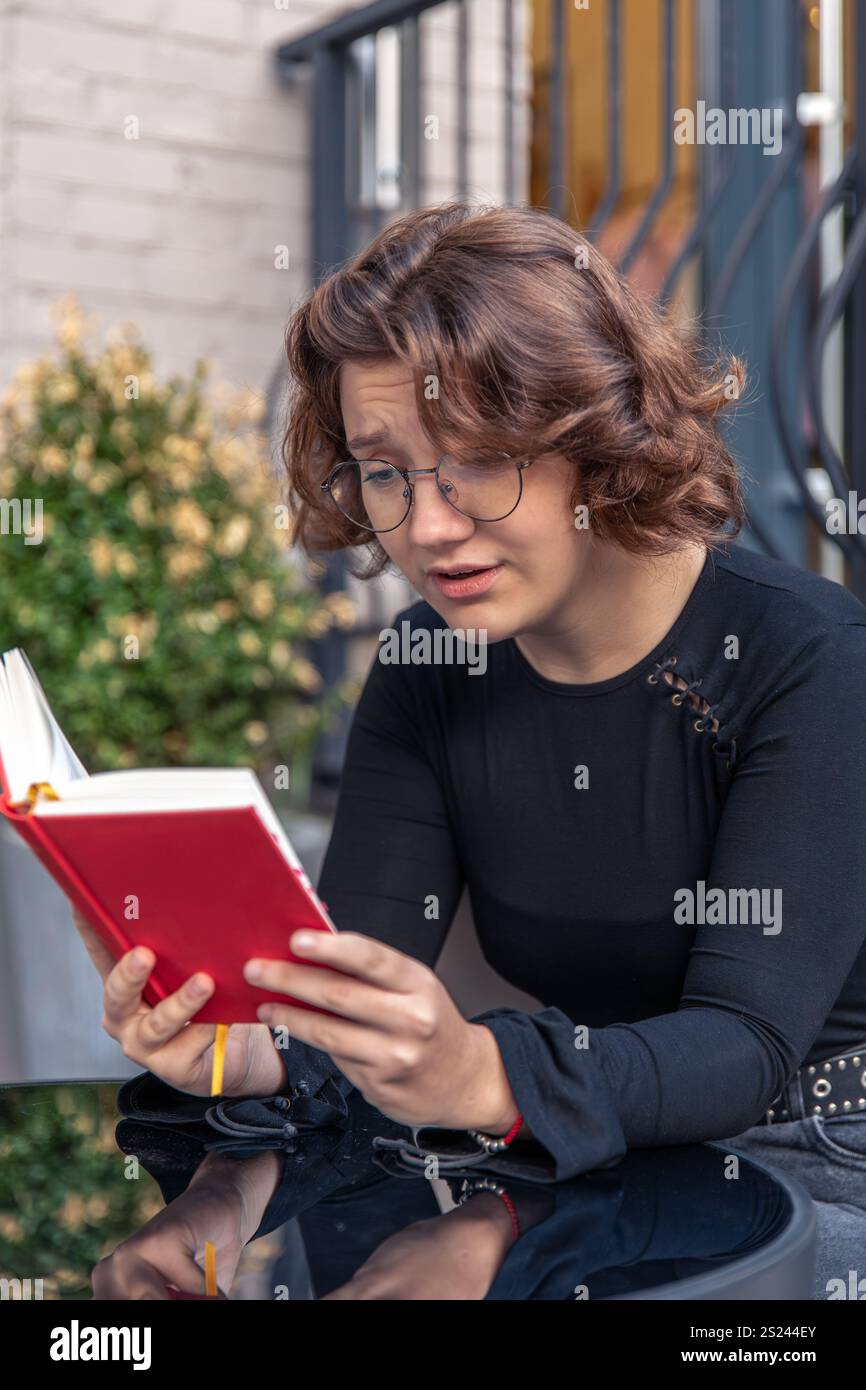 Tired and sleepy young woman reading a book. Emotion concept Stock ...