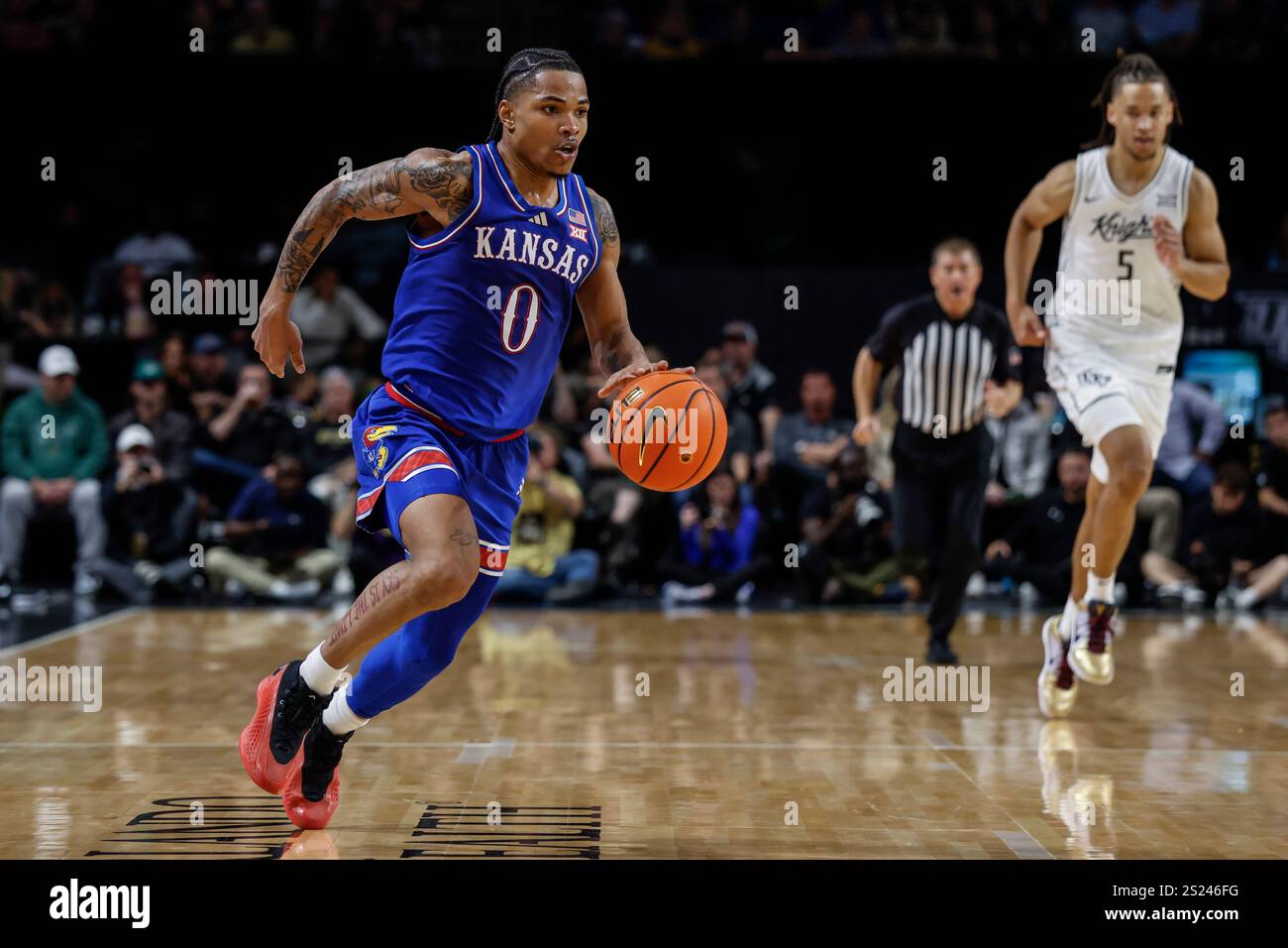 Kansas guard Shakeel Moore (0) brings the ball down court against ...