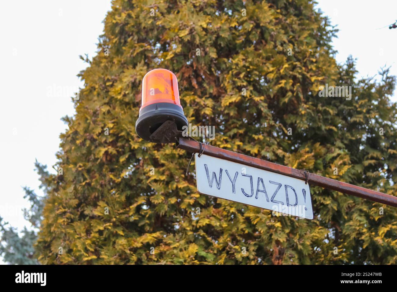 A bright orange warning light illuminates a sign labeling the exit ...