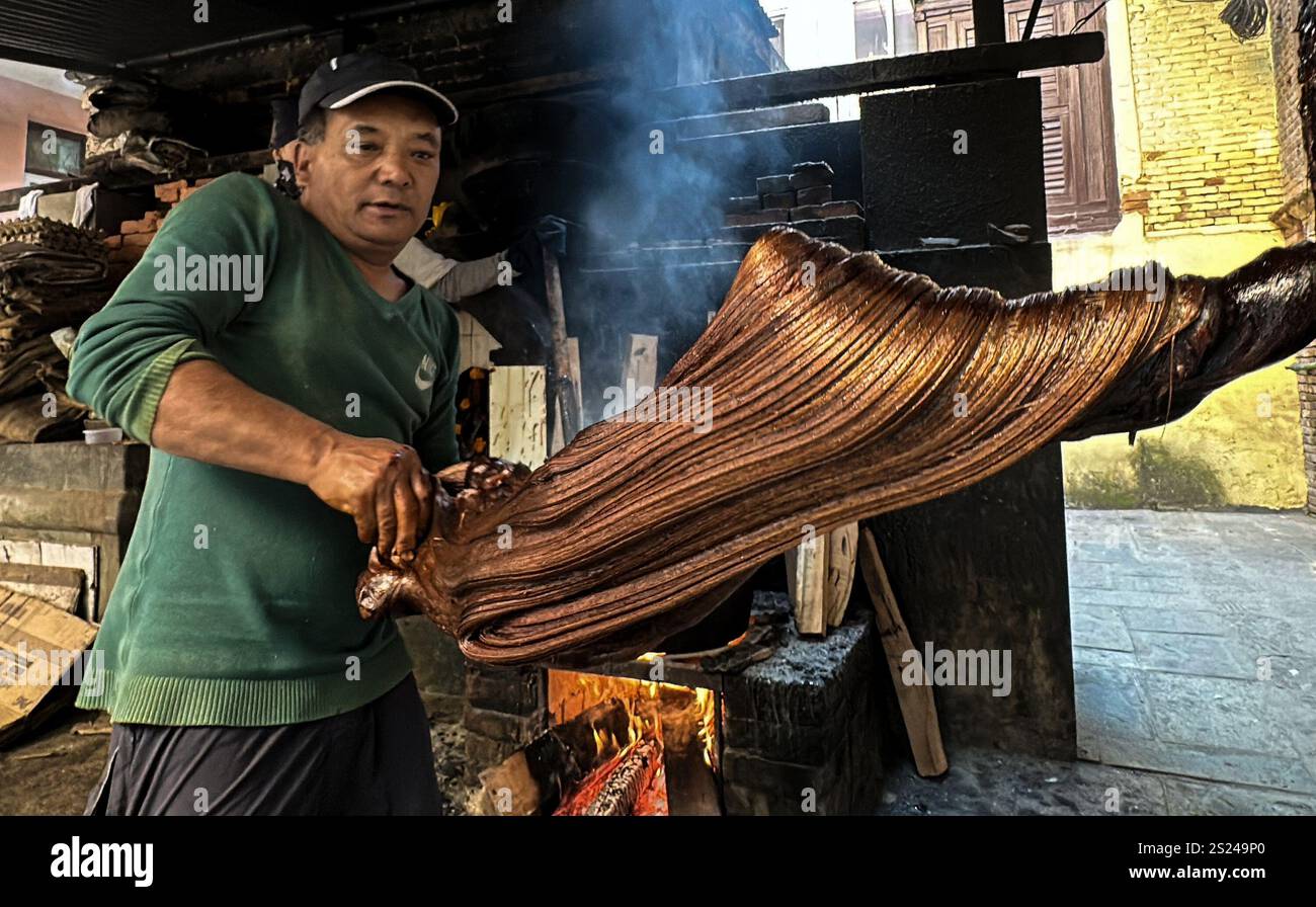 January 6, 2025: A man whips the hard-boiled molasses (Chaaku, in local ...