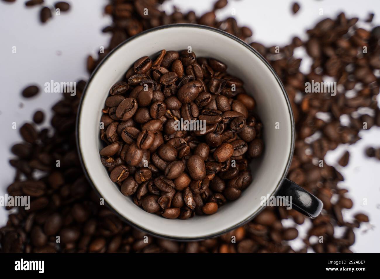 Coffee cup filled with beens. Beens background. Beens all over on a ...