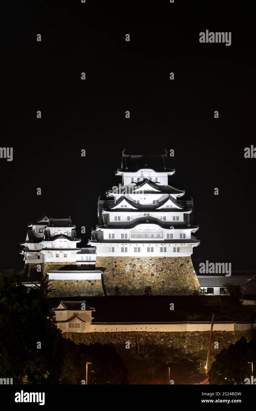 The imposing keep of Himeji castle illuminated at night. The famous ...