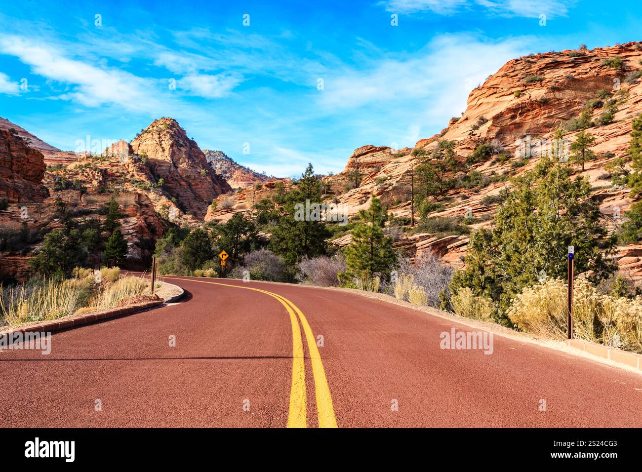 A road with a yellow line down the middle and a sign that says "No U ...