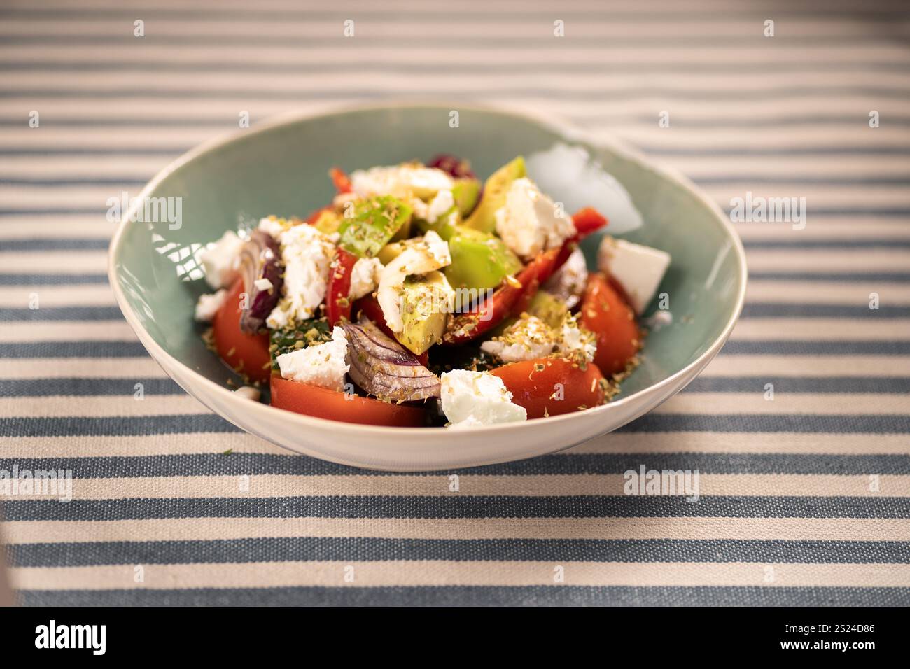 Italian avocado salad with feta, tomatoes, and red onion Stock Photo ...