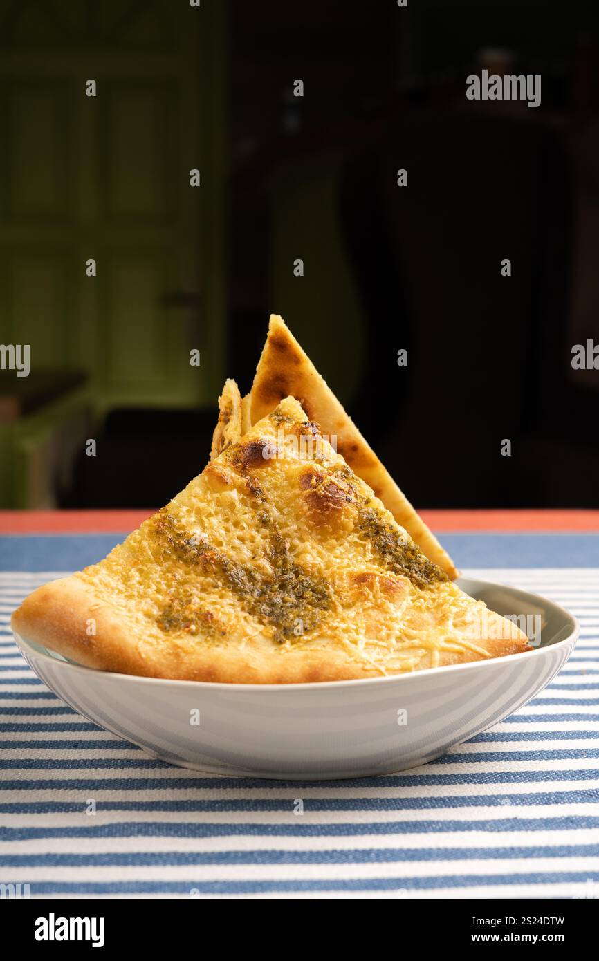 Golden crispy bread triangles with pesto topping Stock Photo - Alamy