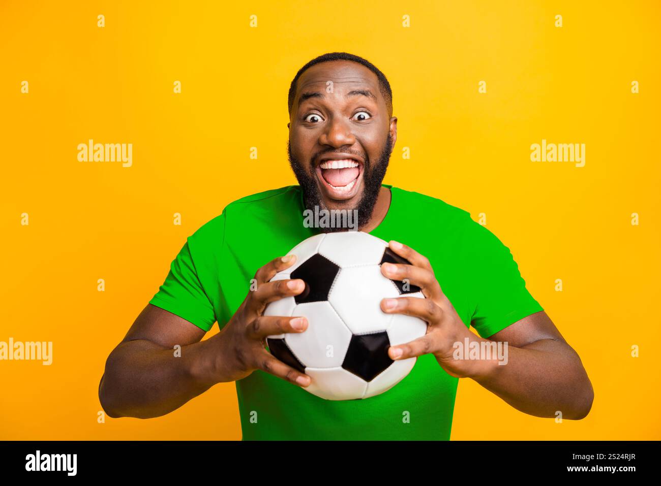 Photo of cute childish rejoicing american man ready to play football ...