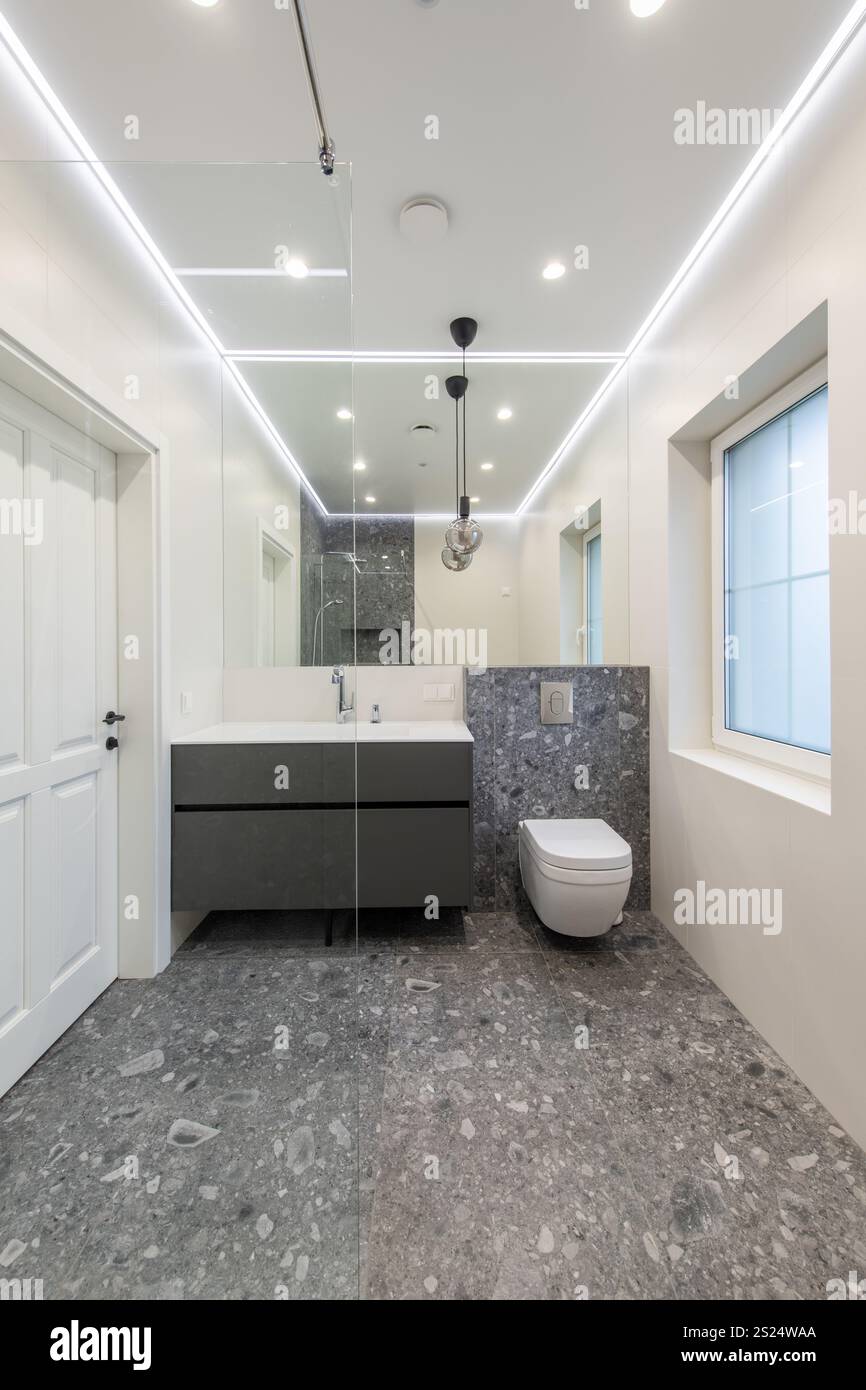 Contemporary bathroom featuring gray tile flooring, minimalistic gray ...