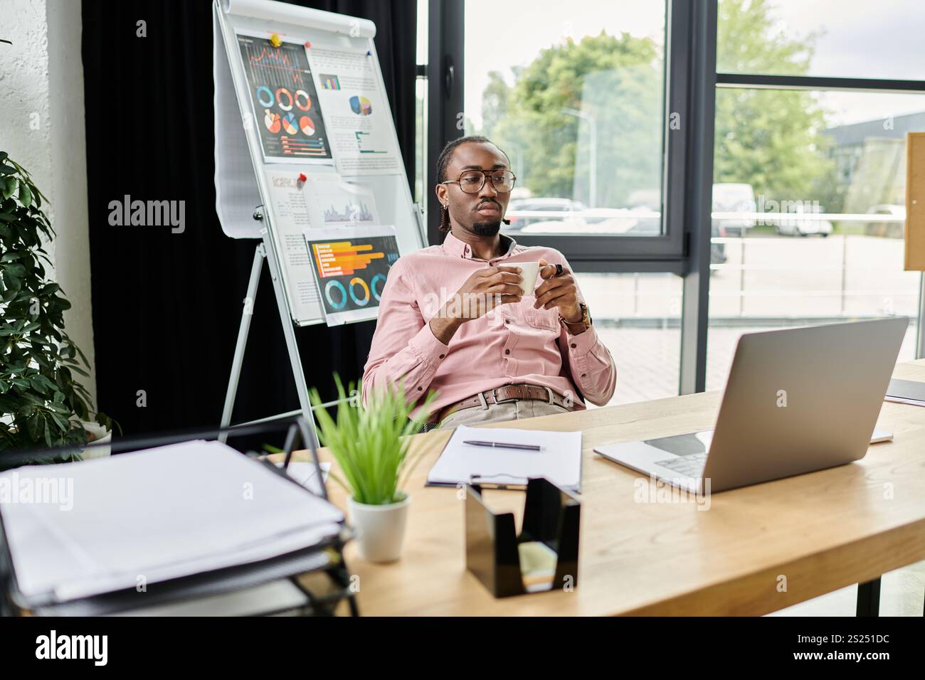 Young man engaged in remote work while comfortably seated in a stylish ...
