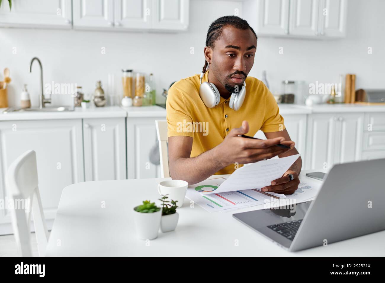 A focused young man engages in remote work, surrounded by a bright ...