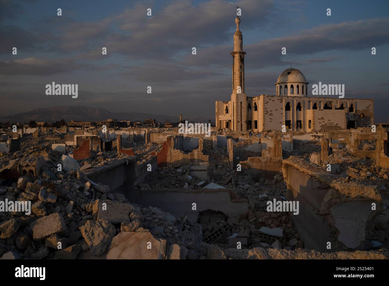 A heavily damaged mosque is seen surrounded by buildings that were ...