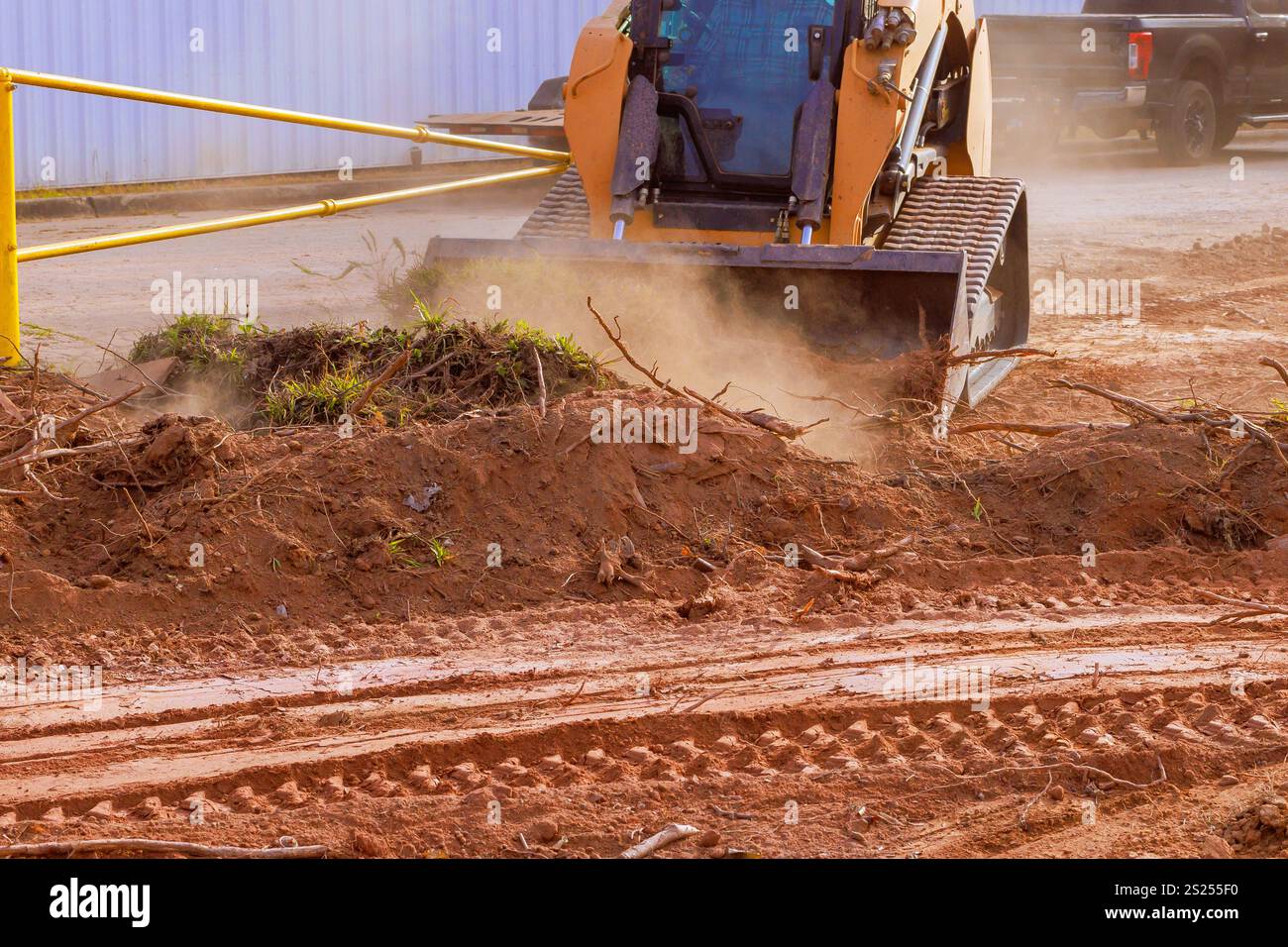Heavy machinery works diligently to remove dirt, debris at an active ...