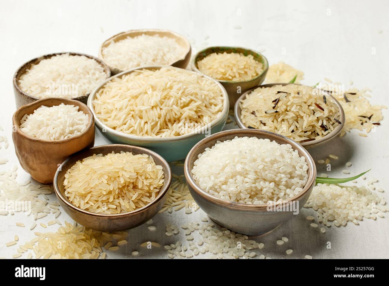 different types of rice on white kitchen table surface Stock Photo - Alamy