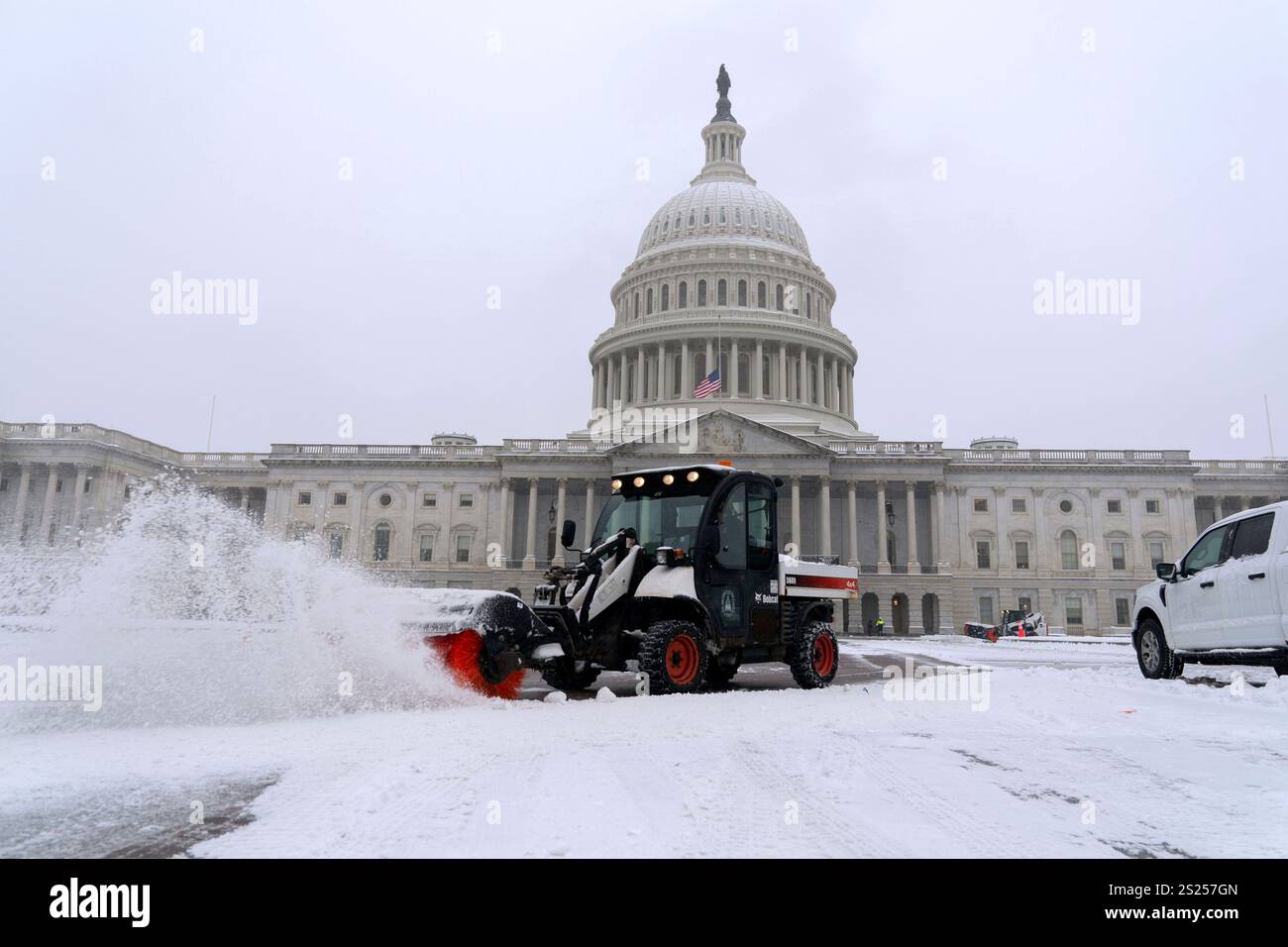 A snowplow clears the area as snow blankets Capitol Hill ahead of a ...