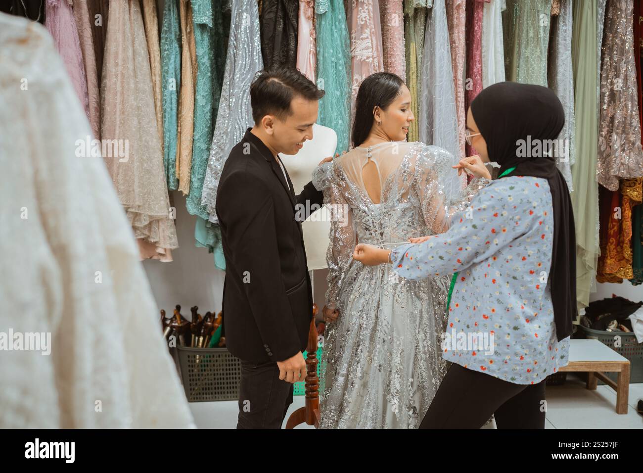 An Elegant Dress Fitting Session Featuring Fashion Designers and Models Together Stock Photo - Alamy