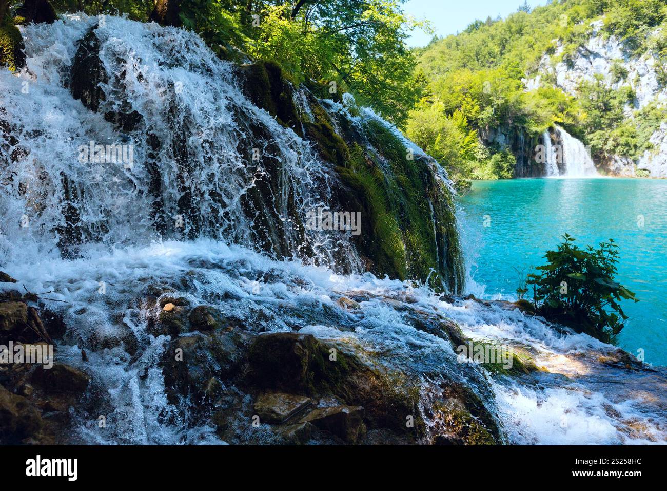 Small waterfall (closeup) and azure limpid lake in Plitvice Lakes ...