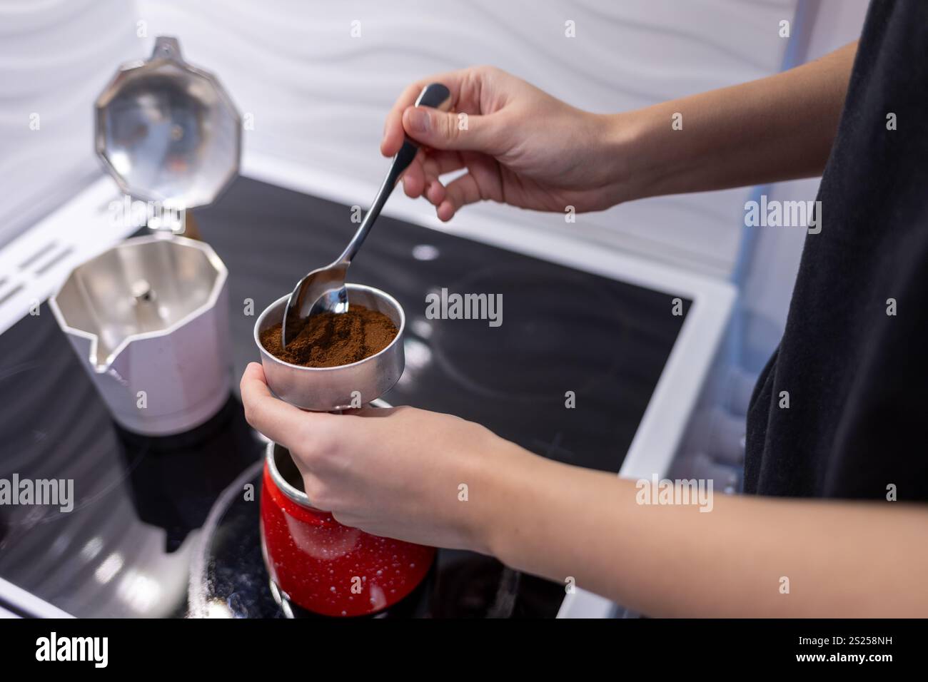 making coffee in a coffee pot on an electric stove, morning coffee in a ...