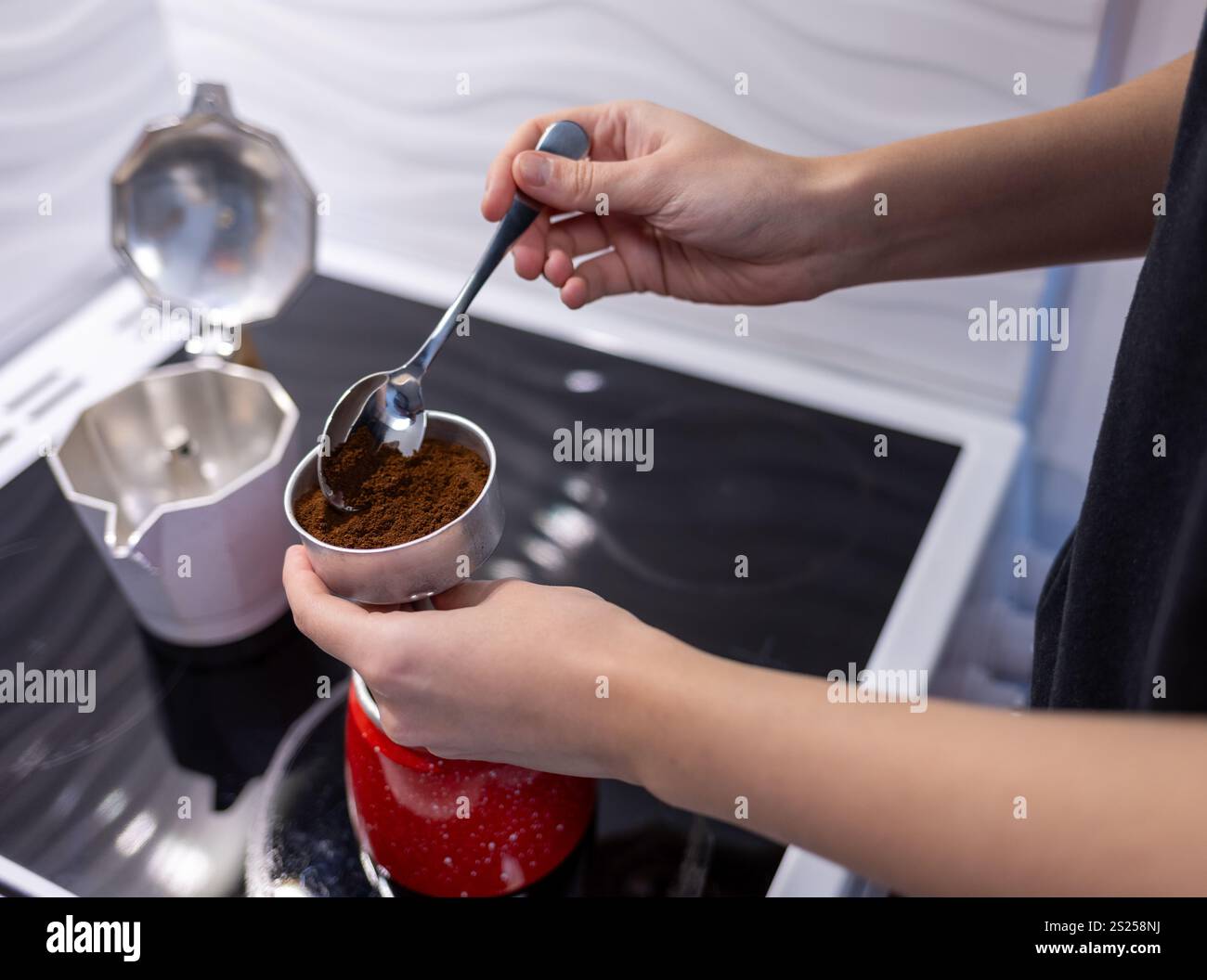 making coffee in a coffee pot on an electric stove, morning coffee in a ...
