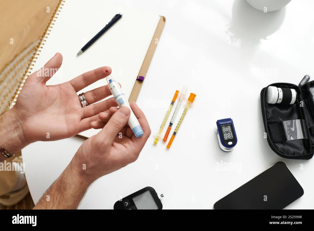 A young man with diabetes uses insulin while managing his daily routine ...