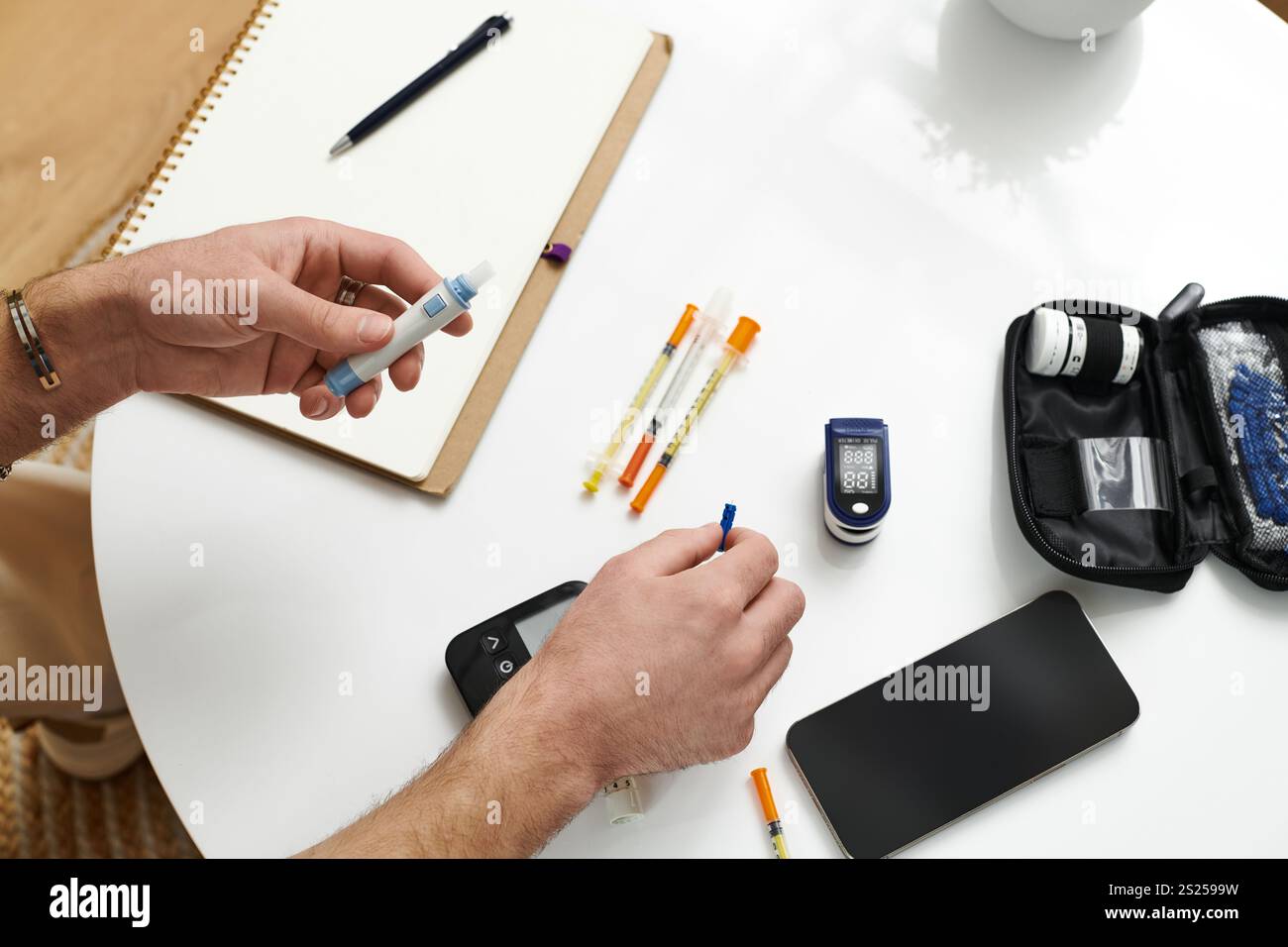 A young man with diabetes manages his insulin and blood sugar in his ...