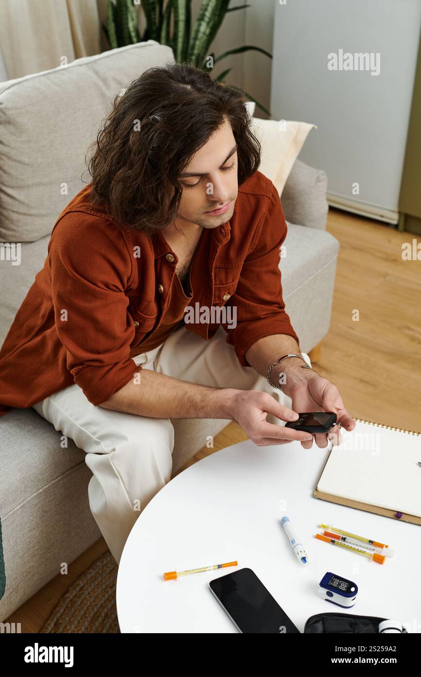 Young man practices self-care at home while monitoring his diabetes ...