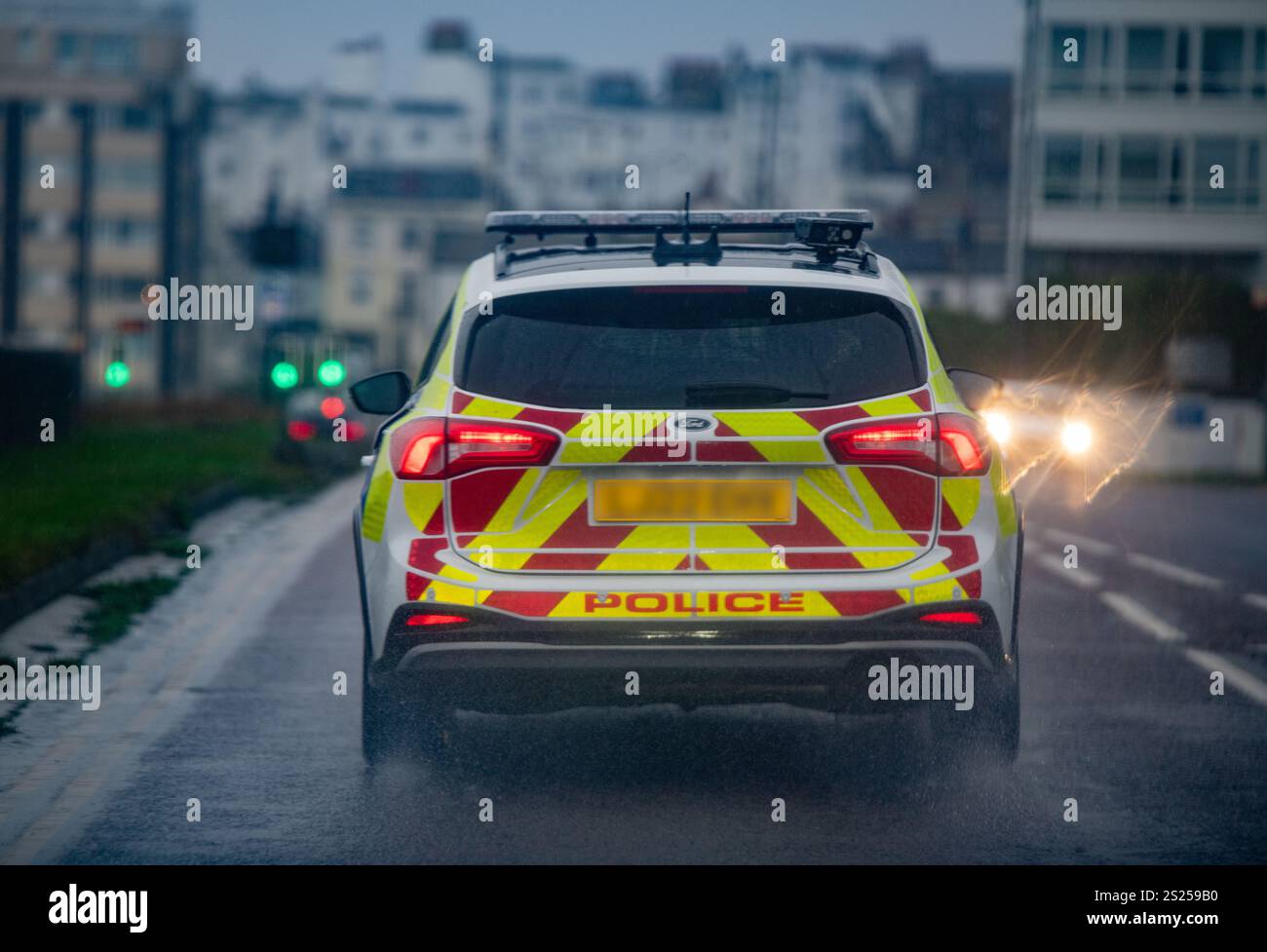 Police car from behind driving down road number plate obscured hi-res ...