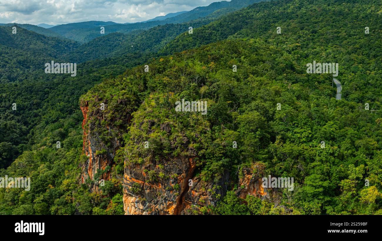Aerial panoramic view of lush green hills and valleys intersected by a ...
