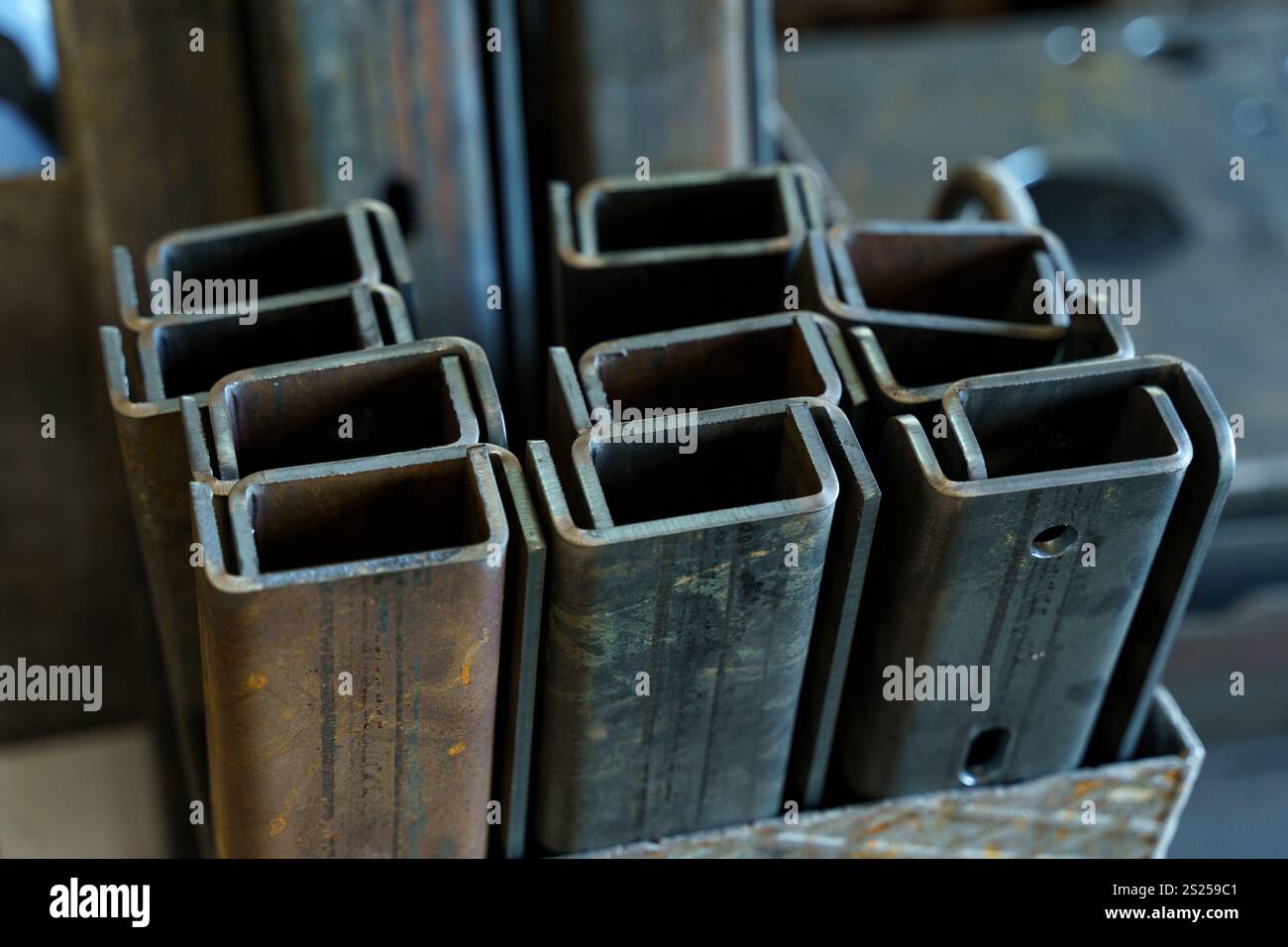 Rows of sturdy metal tubes stand in a workshop, showcasing their ...