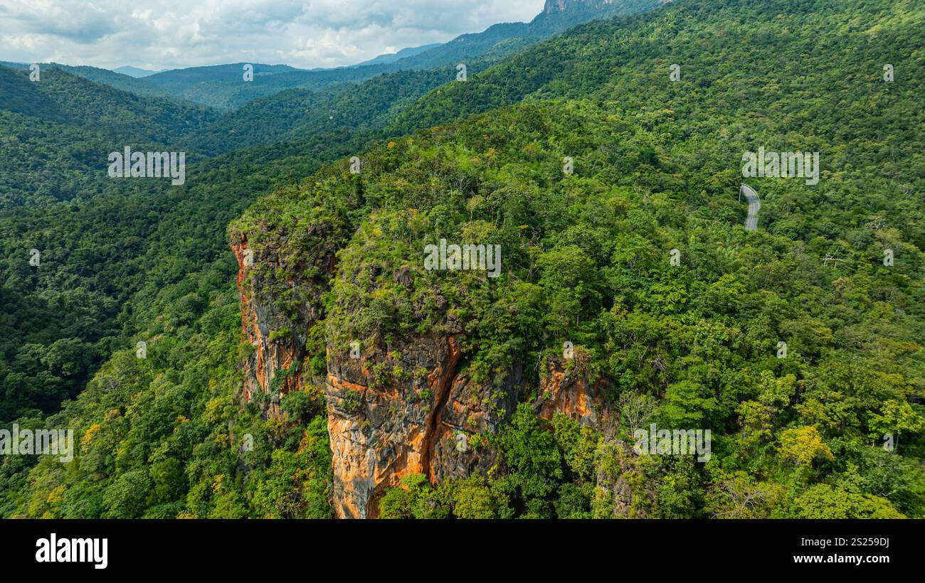 Aerial panoramic view of lush green hills and valleys intersected by a ...