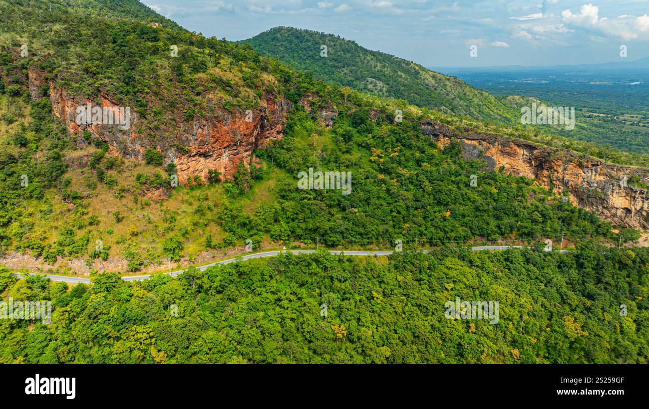 Aerial panoramic view of lush green hills and valleys intersected by a ...