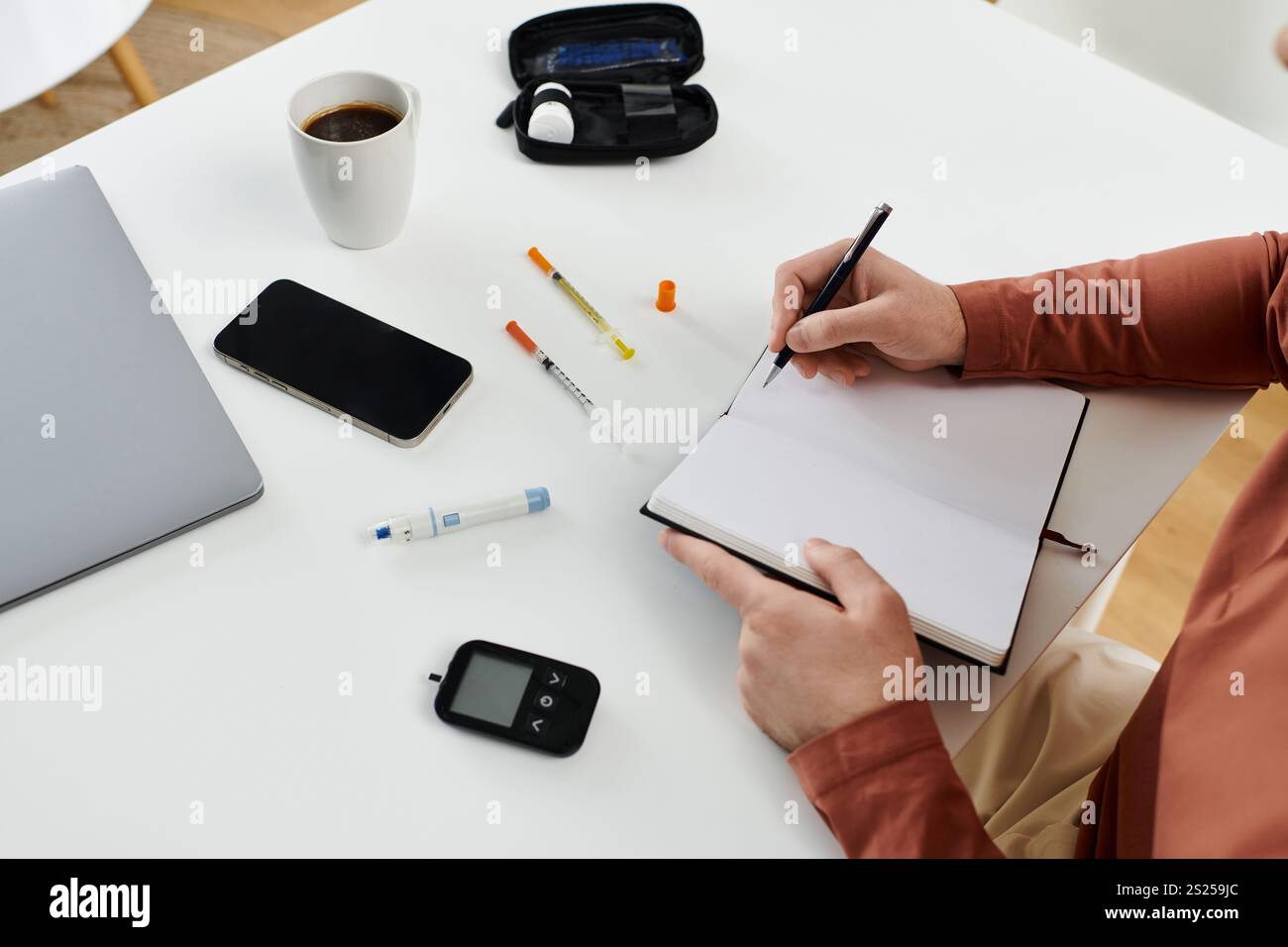 A young man records his daily diabetes management routine at home with ...