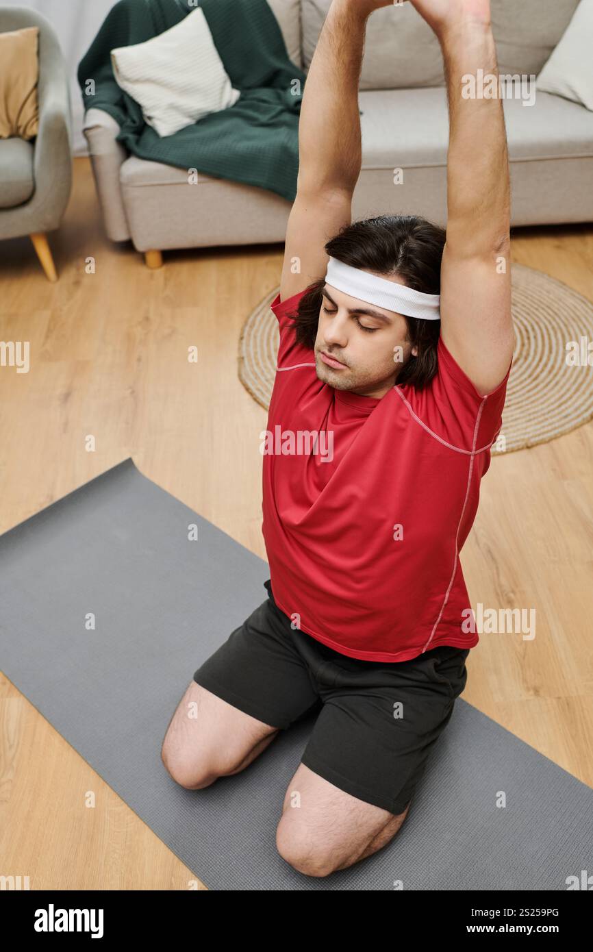 A fit young man practices his daily workout routine in his modern ...