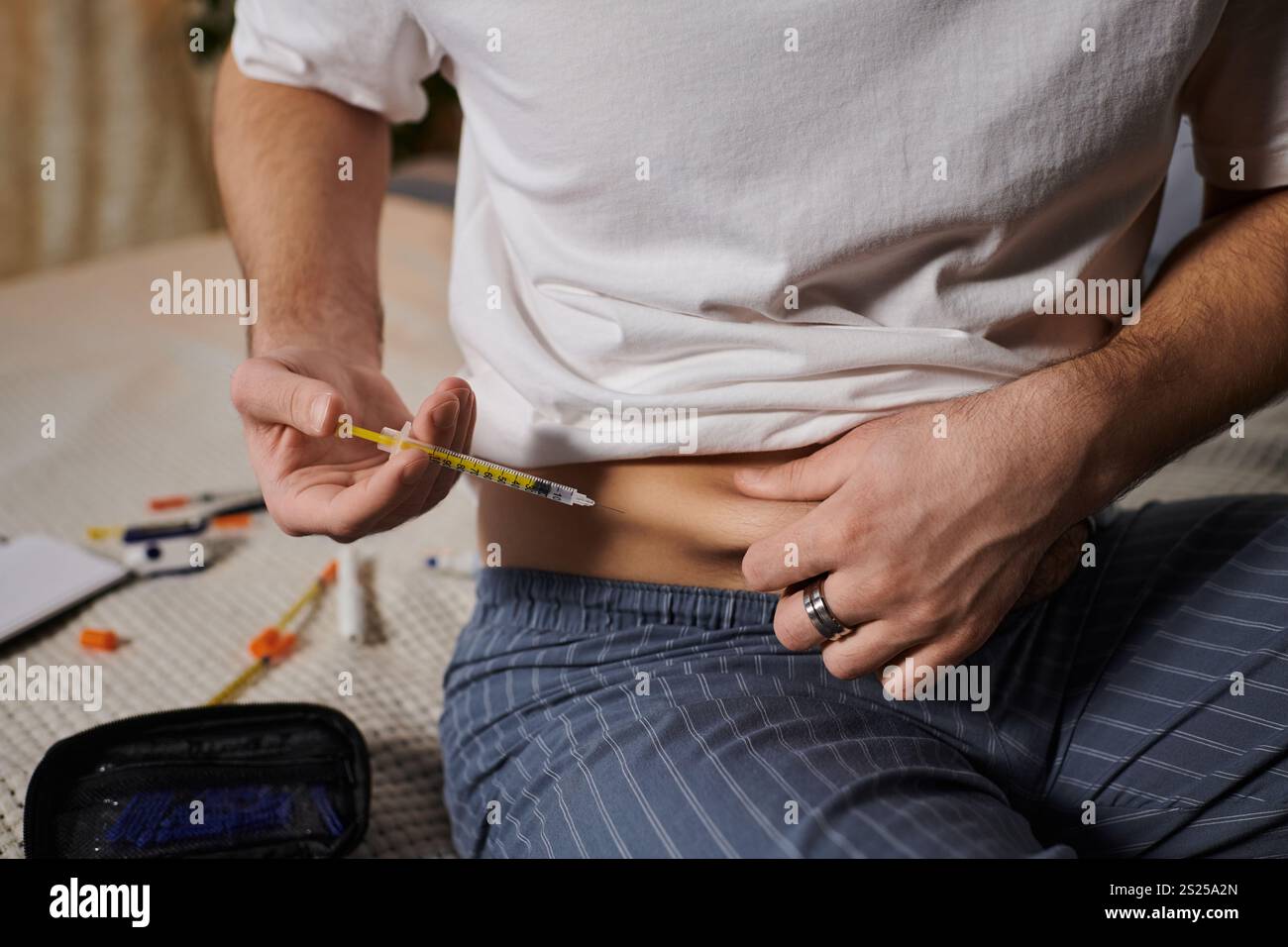 Young man demonstrates his daily routine managing diabetes in his ...