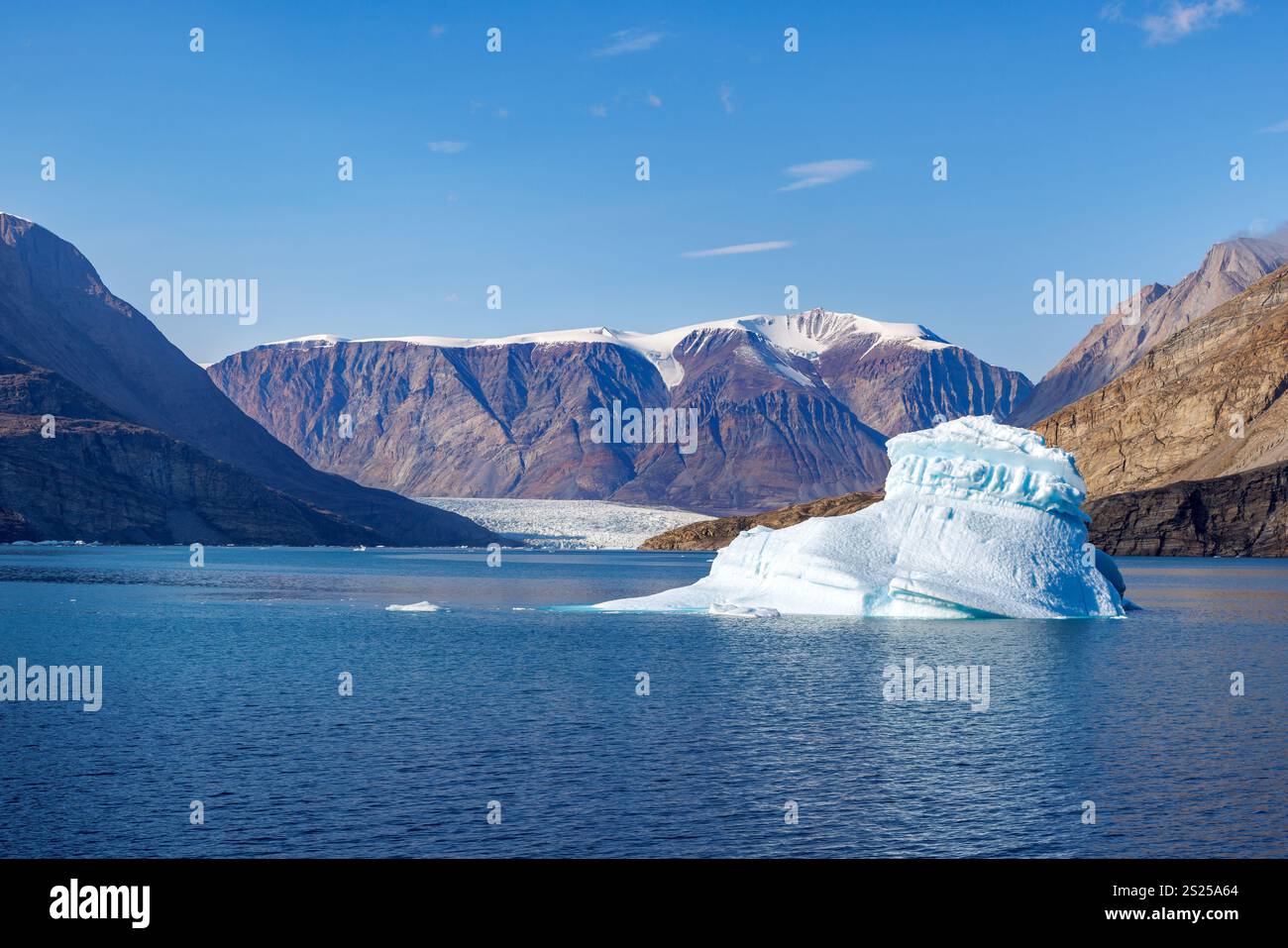 A blue iceberg in the waters of Dickson fjord, Northeast Greenland ...