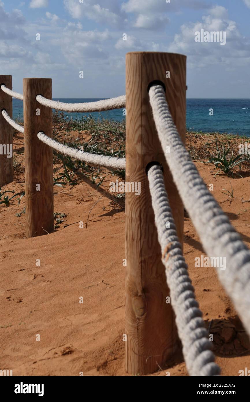 Rope fence on the beach with blue sky and sea in background in Netanya ...