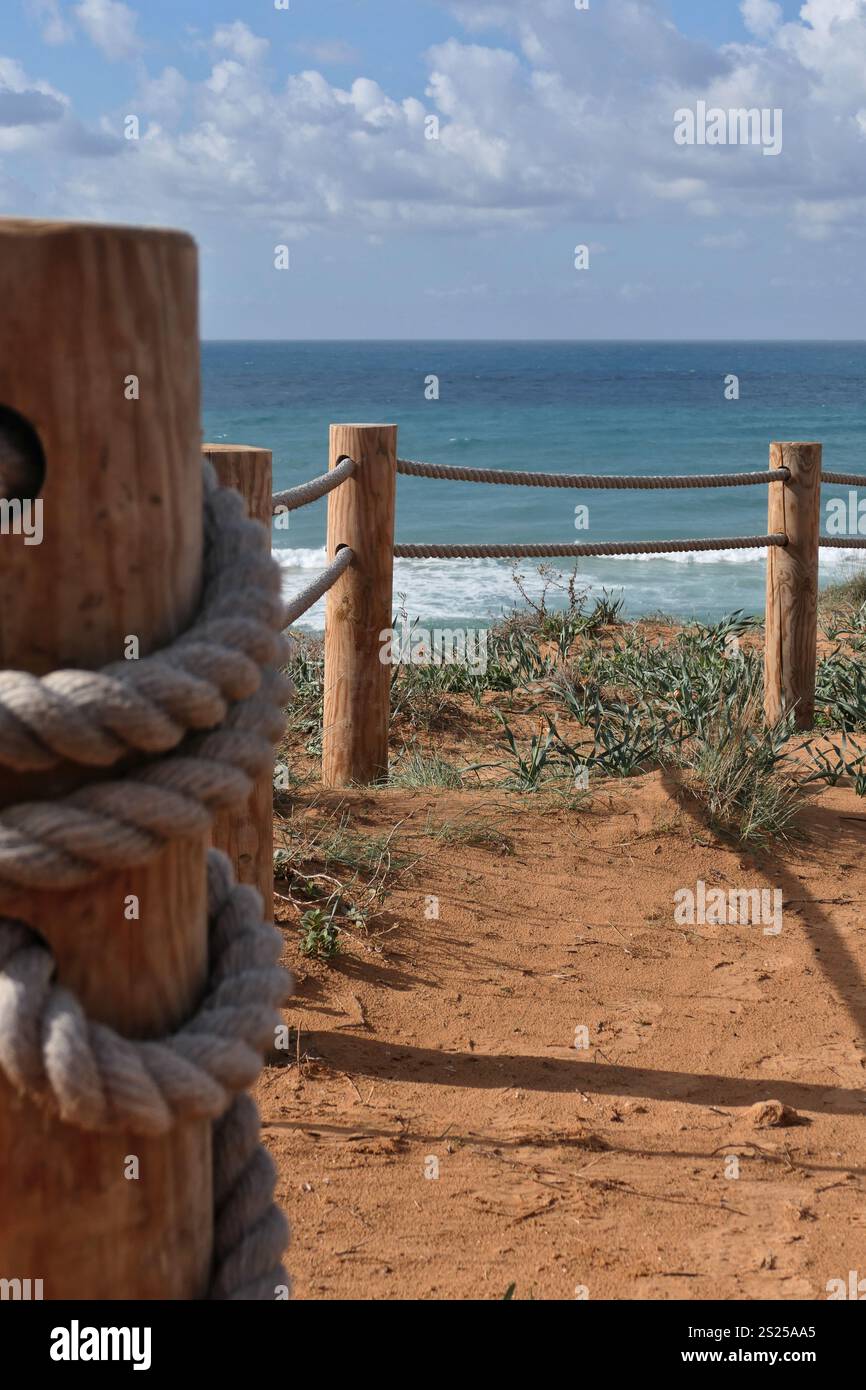 Rope fence on the beach with blue sky and sea in background in Netanya ...