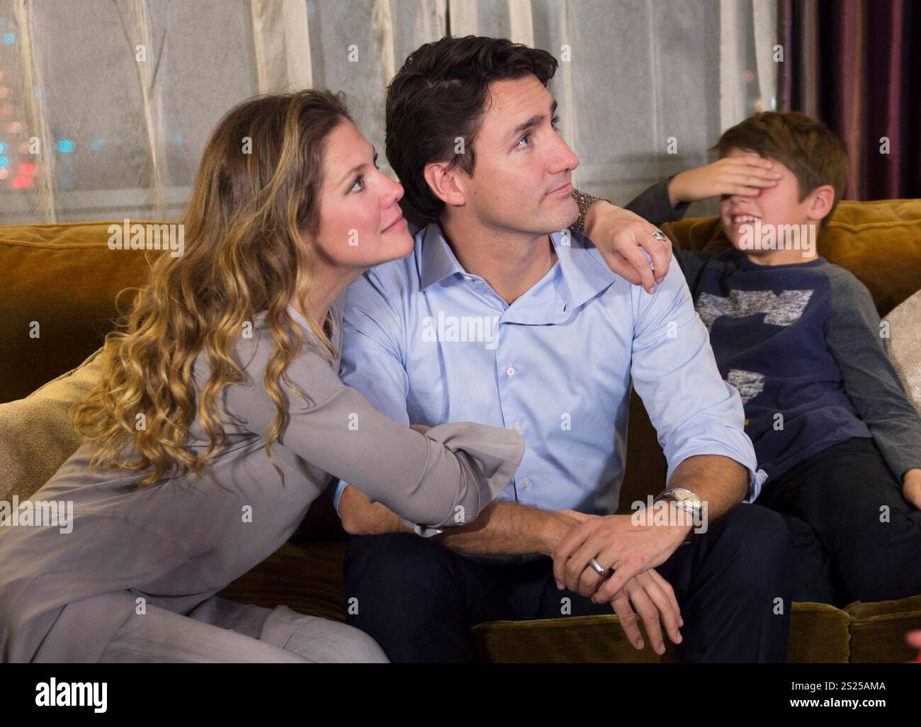 FILE - Xavier Trudeau, right, covers his eyes as Liberal leader Justin ...