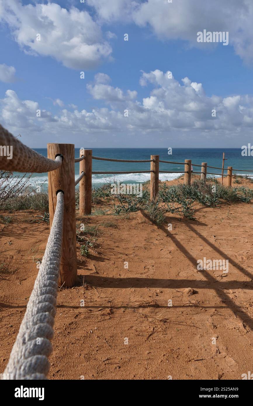 Rope fence on the beach with blue sky and sea in background in Netanya ...