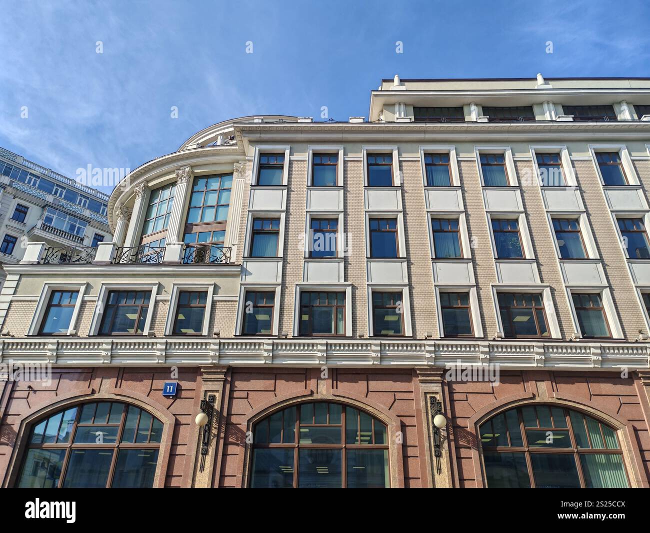 large residential building with a pink facade, decorated with classical ...