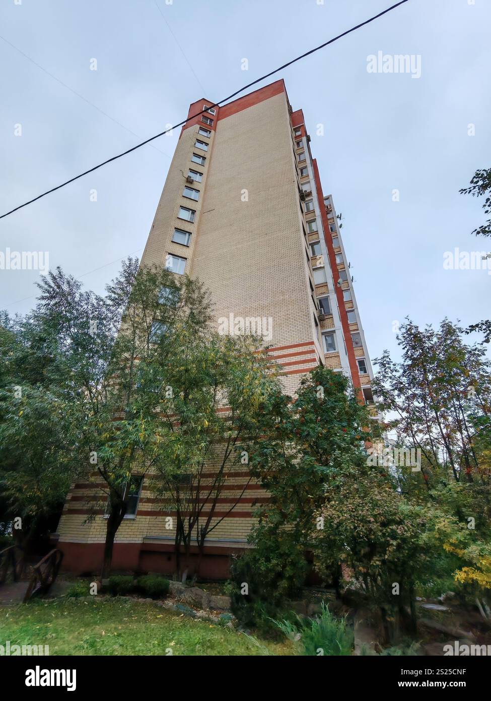 A pastel-colored high-rise residential building with curved balconies ...