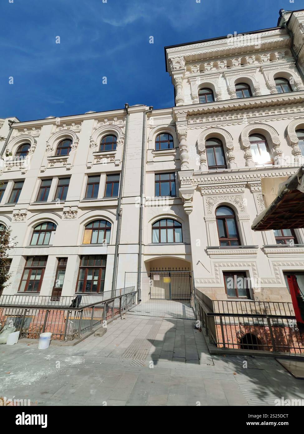 A historic neoclassical building with arched windows, intricate ...