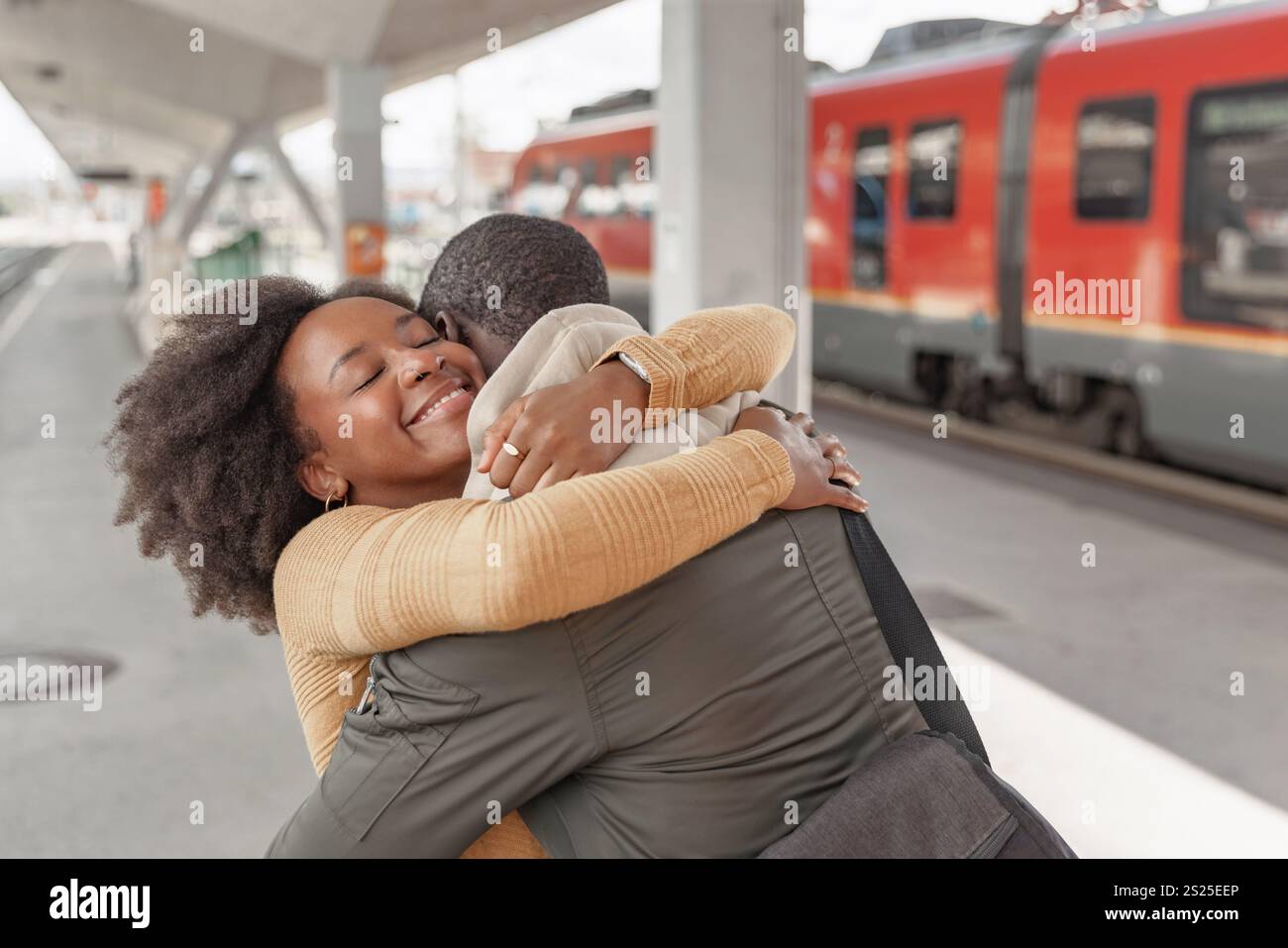 African American couple meeting at a railway station near arrived train ...