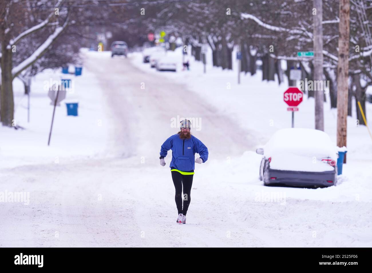 A runner makes his way through a snow-covered street in Indianapolis ...