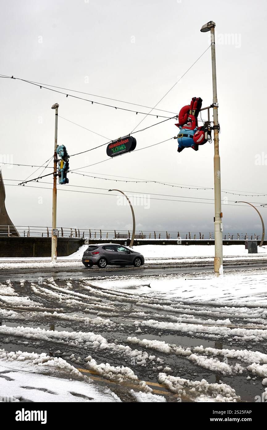 A solitary car drives along a deserted seafront in Blackpool during the ...