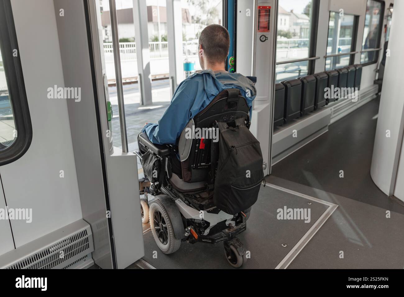 Man with disability on electric wheelchair exit a train. Accessible ...