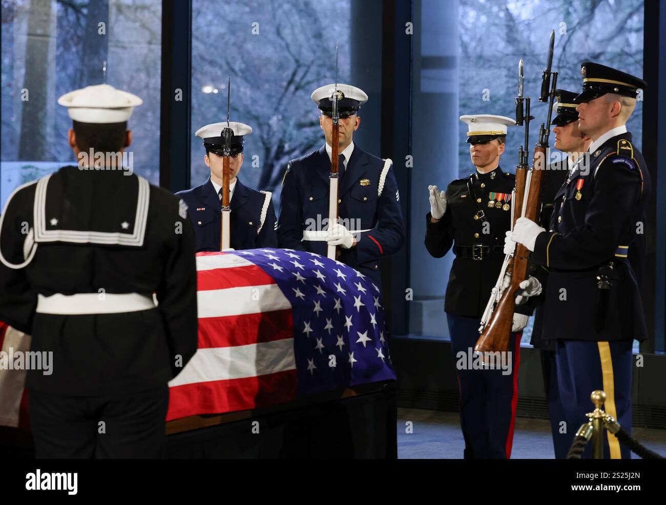 Members of the joint services military honor guard conduct a changing of the guard next to the ...