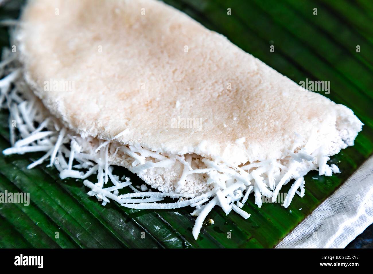 Traditional Brazilian tapioca with coconut served on a banana leaf ...