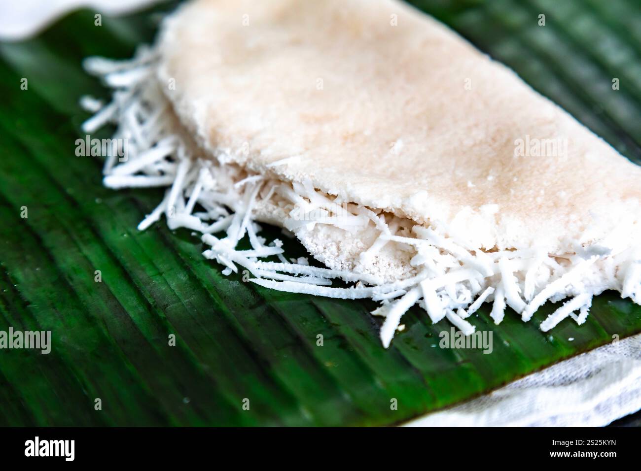 Traditional Brazilian tapioca with coconut served on a banana leaf ...