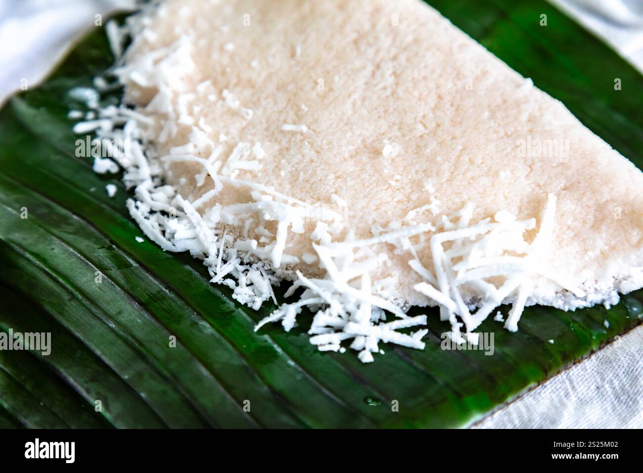 Traditional Brazilian tapioca with coconut served on a banana leaf ...