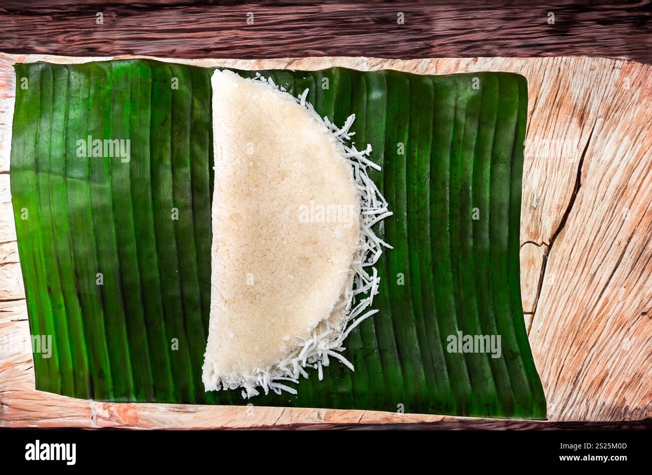 Traditional Brazilian tapioca with coconut served on a banana leaf ...