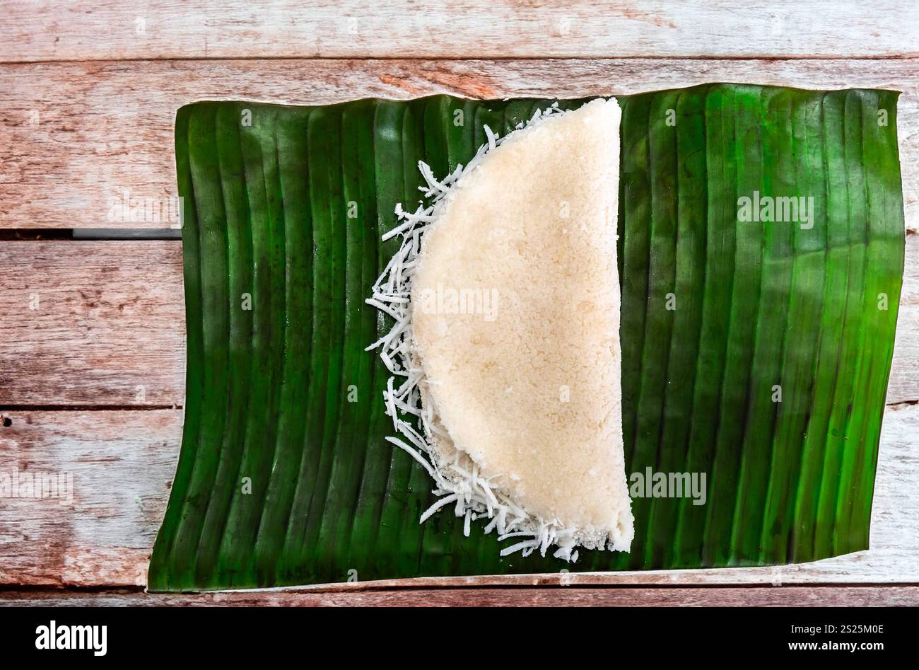Traditional Brazilian tapioca with coconut served on a banana leaf ...